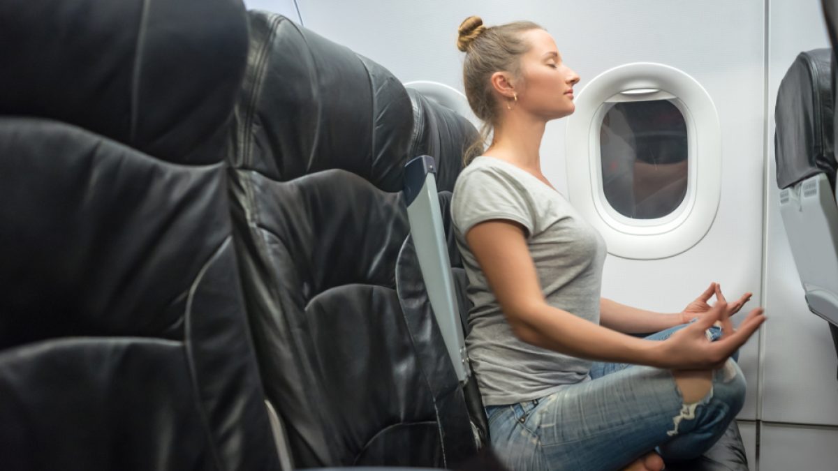 Here's the Best Way to Do Yoga on An Airplane — Best Life