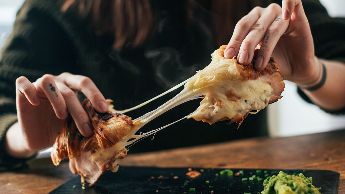 10 Signs You’re Eating Too Much Cheese, According to Doctors